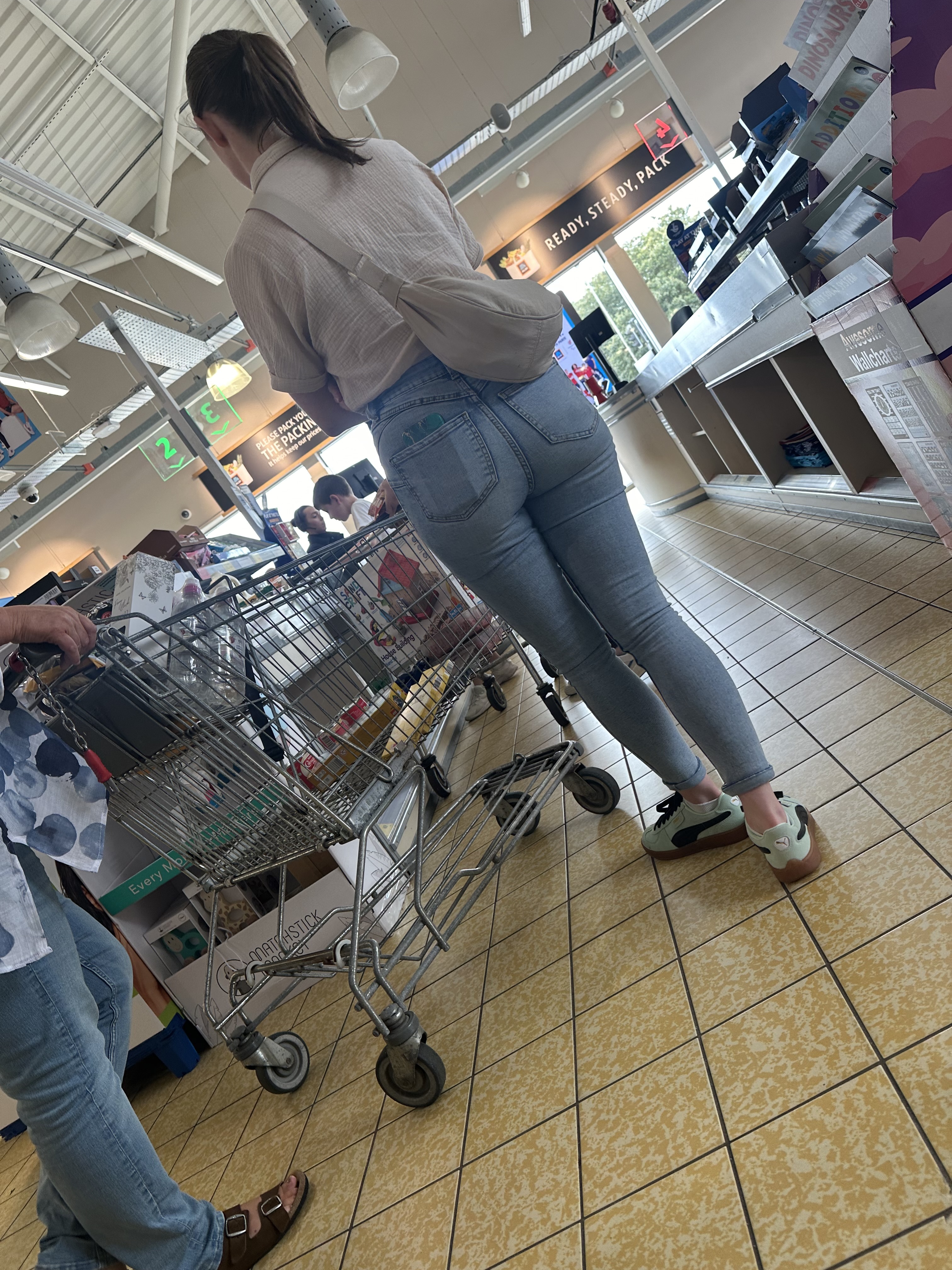 Tight cheek hugging jeans on brunette in line at shop 🍑 - Tight Jeans ...